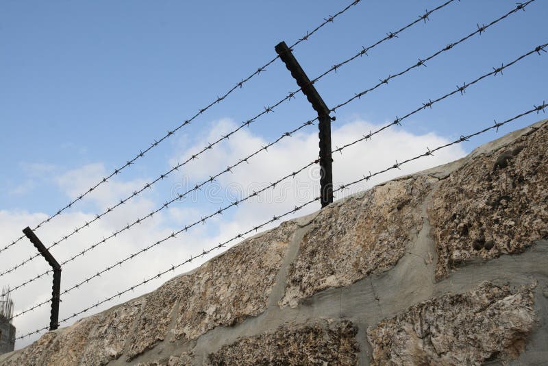 Barbed Wire Over the Stone Wall Stock Image - Image of wall, clouds ...