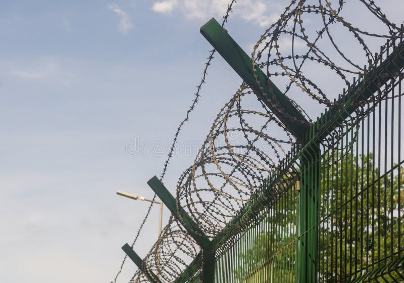 Fence with Razor Barbed Wire. Guarded Area. Military Base. Razor Wire ...