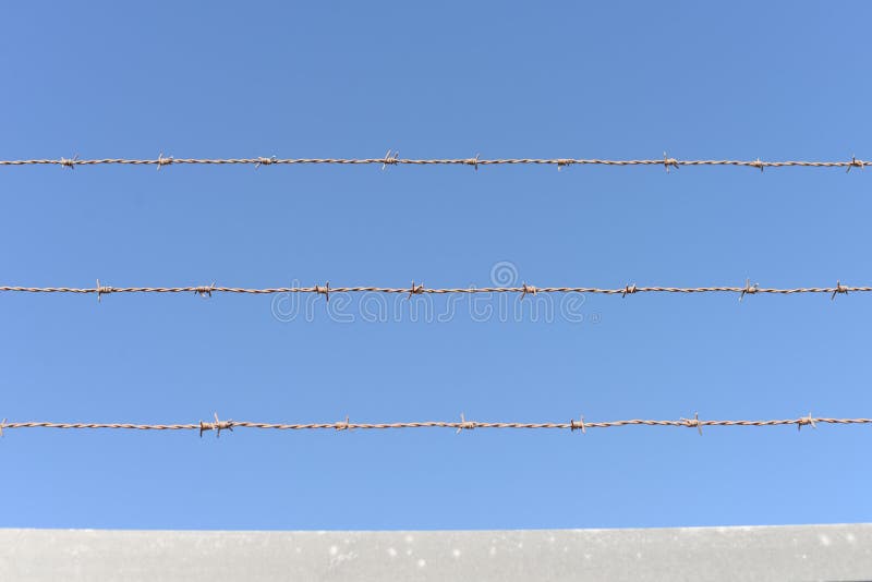 Barbed Wire for Security with Intense Blue Sky Stock Photo - Image of ...