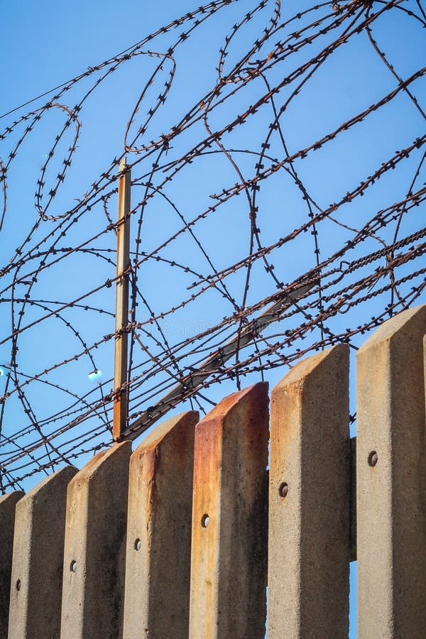 Barbed Wire on Top of a Concrete Wall Stock Photo - Image of shadow ...