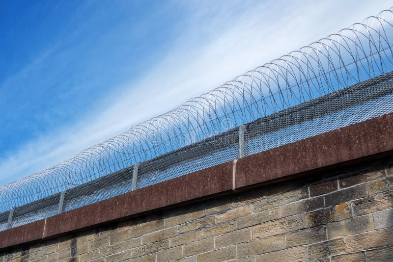 Barbed wire on a wall stock photo. Image of trespassing - 59457136