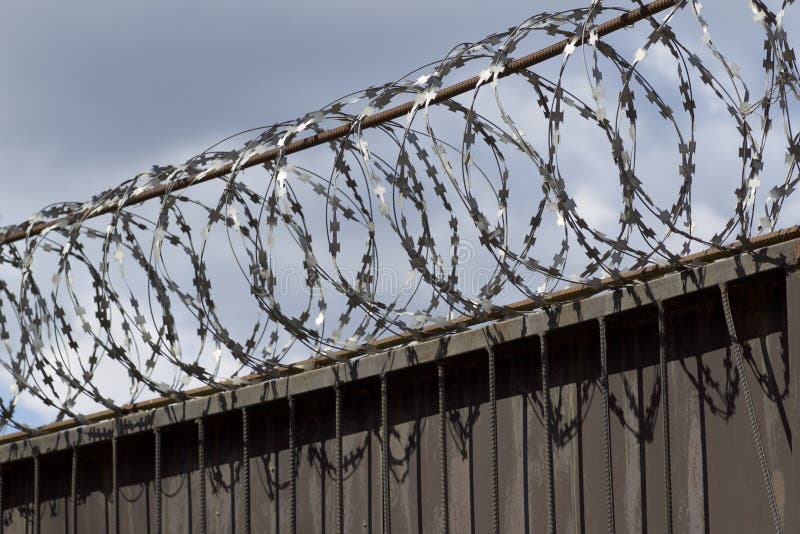 Barbed Wire Wound To the Top of a Fence Stock Image - Image of railing ...