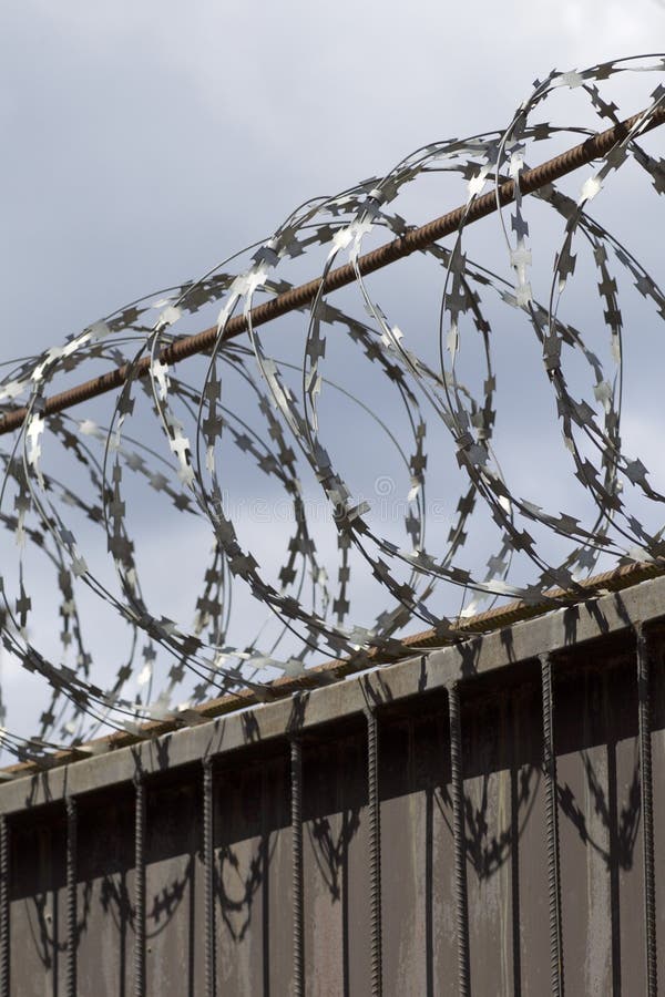 Barbed Wire Wound To the Top of a Fence Stock Image - Image of fencing ...