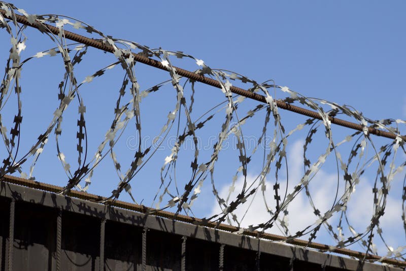 Barbed Wire Wound To the Top of a Fence Stock Image - Image of hedge ...