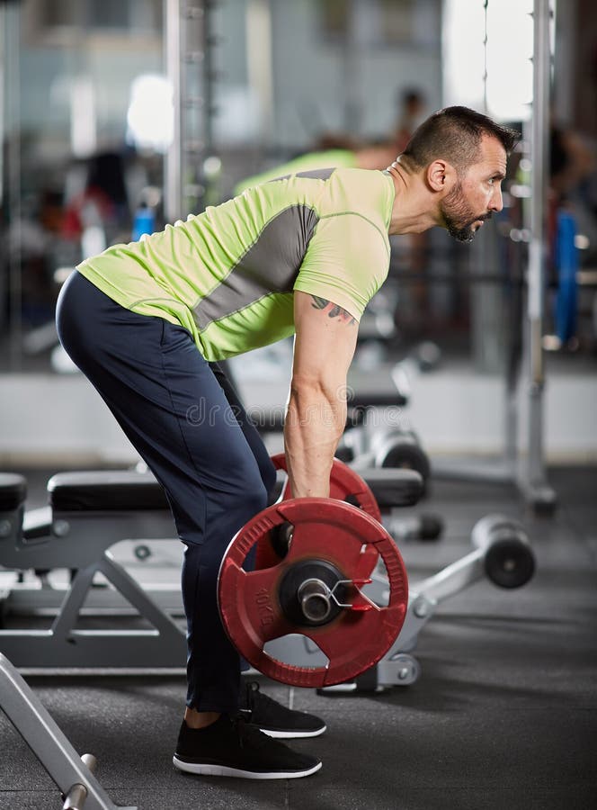 Man On The Arm Press Machine. Bodybuilder With Muscular Back Working ...