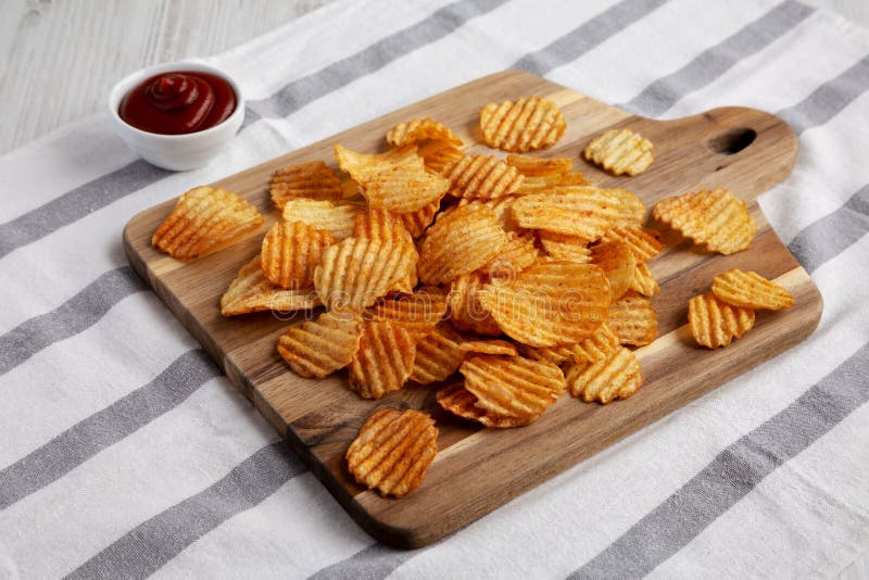 Barbeque Potato Chips on a Wooden Board, Side View Stock Photo - Image ...