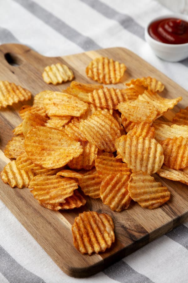Barbeque Potato Chips on a Wooden Board, Side View Stock Photo - Image ...