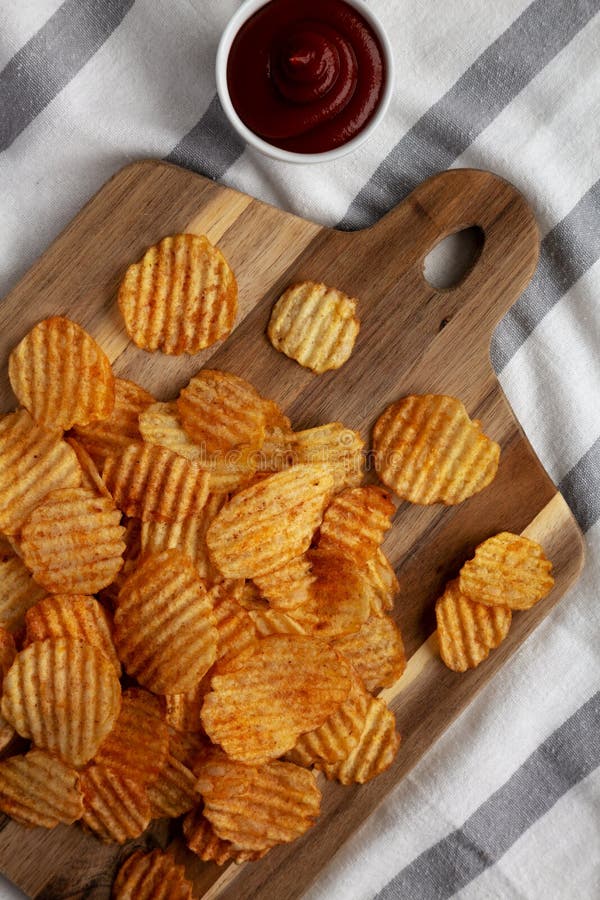 Barbeque Potato Chips on a Wooden Board, Top View. Flat Lay, Overhead ...