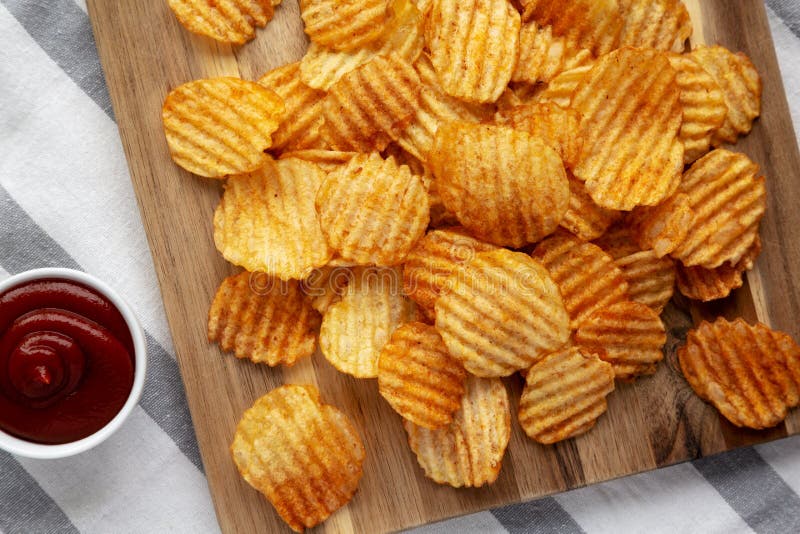 Barbeque Potato Chips on a Wooden Board, Top View. Flat Lay, Overhead ...