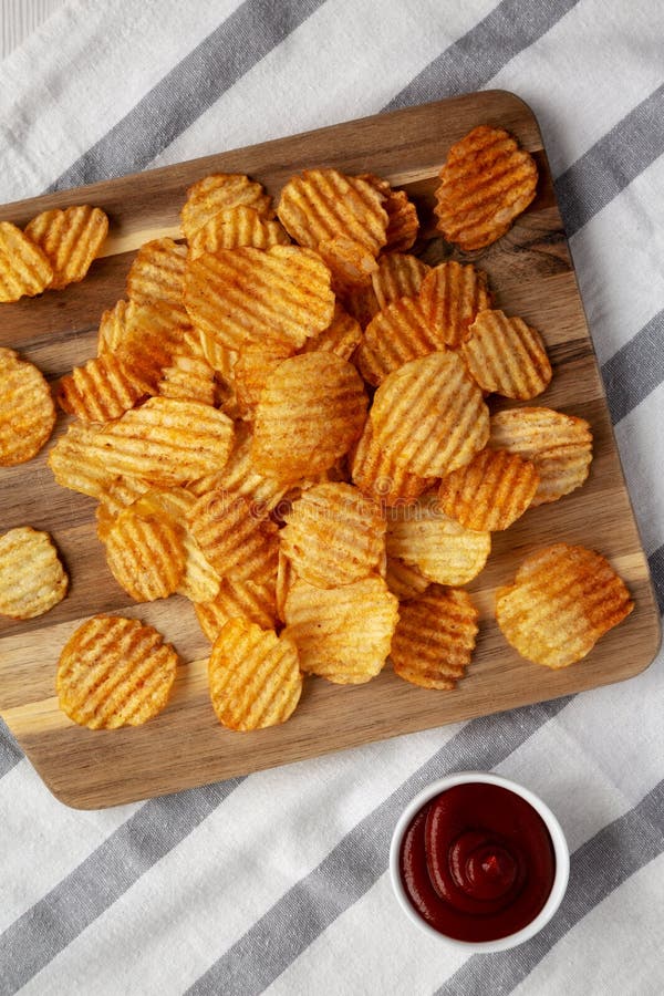 Barbeque Potato Chips on a Wooden Board, Top View. Flat Lay, Overhead ...