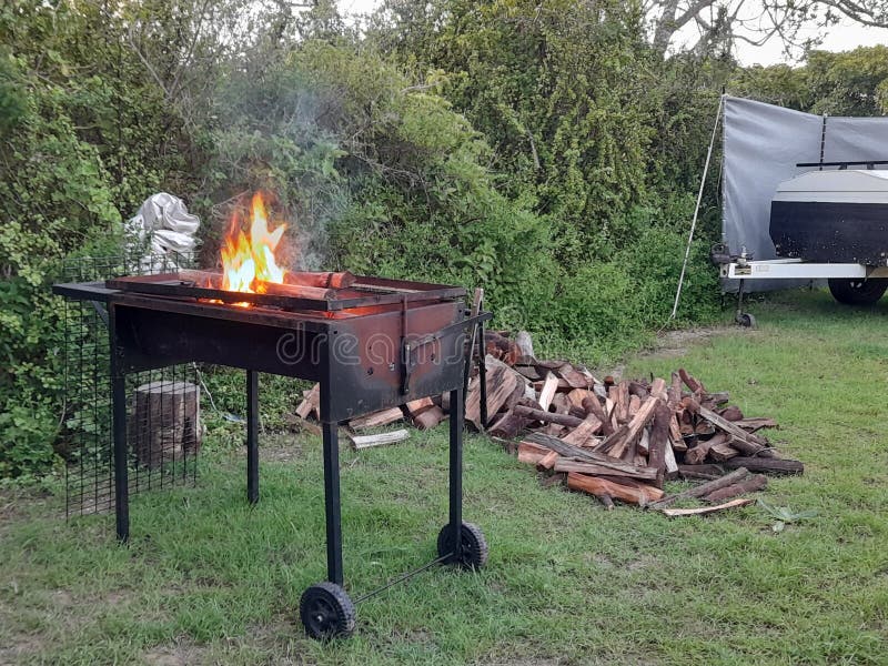 Barbeque Stand with Fire Wood Stock Photo - Image of holiday, braai ...