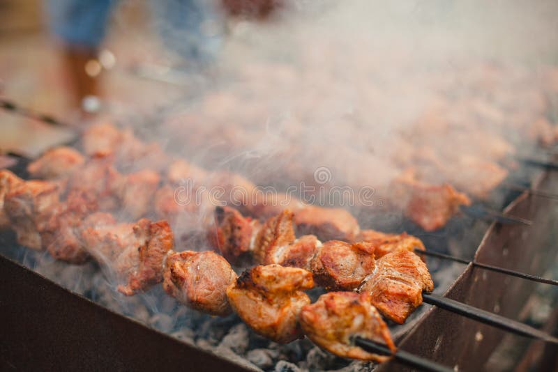 Barbeque Sticks with Meat, on the Grill and Heavy Smoke Above Brazier ...