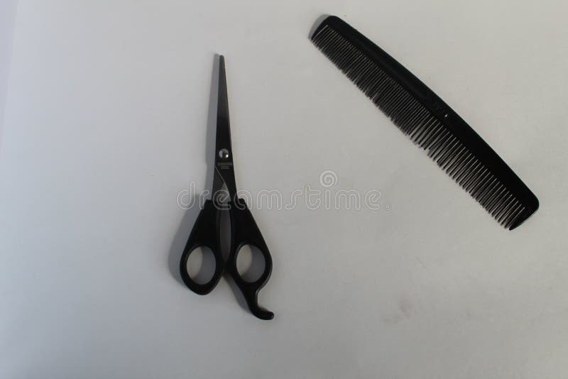 Barber`s Scissors and Comb Lie Side by Side on a White Background Stock ...