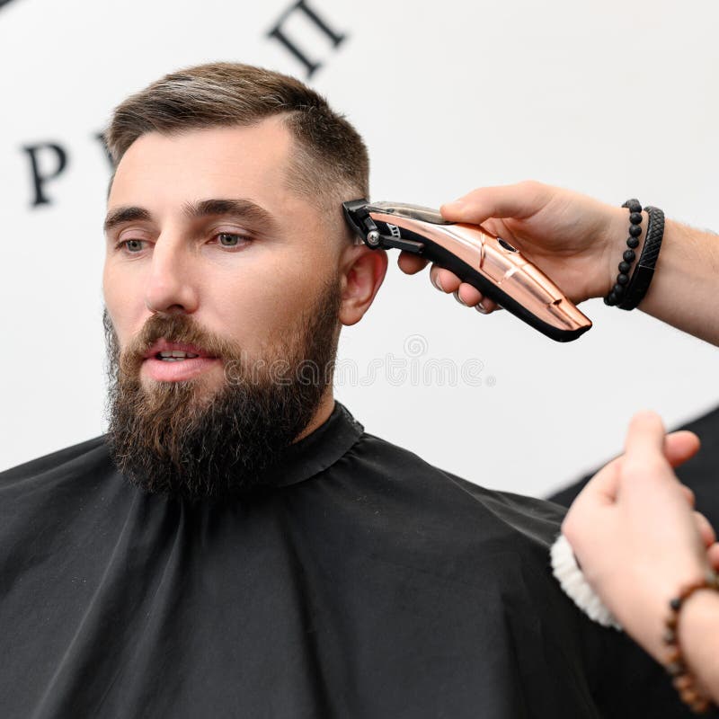 A Barber Cuts a Man with a Beard in a Barber Shop. Short Haircut of the ...