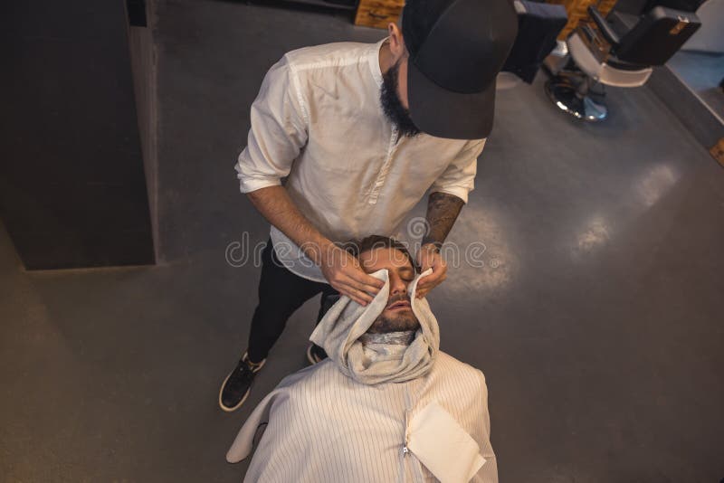 Barber Drying the Clients Face with the Towel Stock Image - Image of ...
