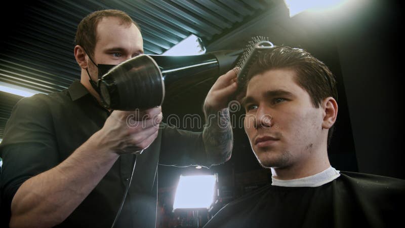 Barber Drying Out His Client`s Hair Using a Hair Dryer Stock Image ...