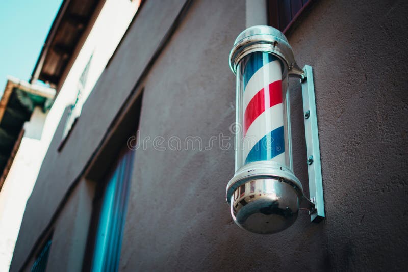 A Barber Pole Hung on the Wall of a Building Facade Stock Image - Image ...