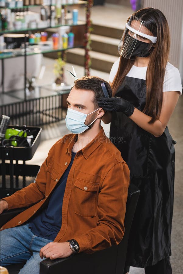Barber in Protective Equipment Holding Scissors Stock Photo - Image of ...