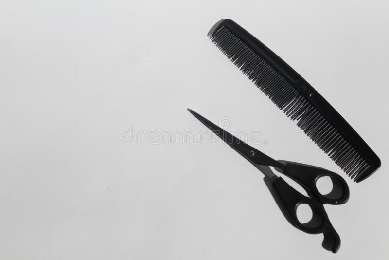 Barber`s Scissors and Comb Lie Side by Side on a White Background Stock ...