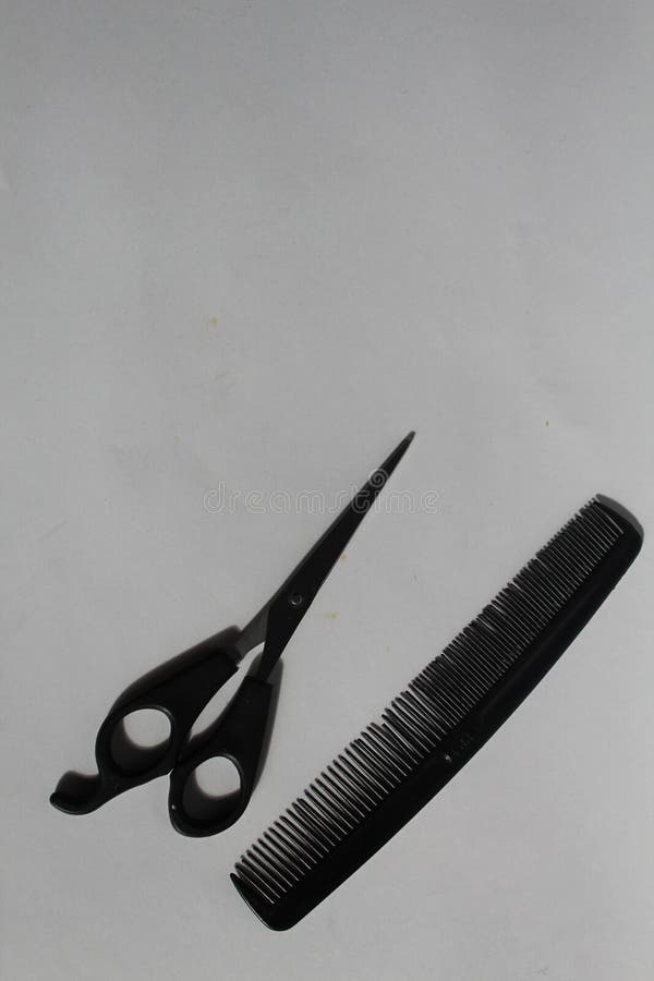 Barber`s Scissors and Comb Lie Side by Side on a White Background Stock ...