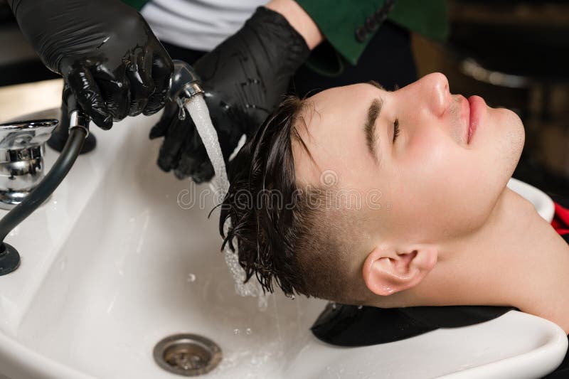 Barber Shampooing Washing a Male Clients Head in the Sink. Stock Image ...