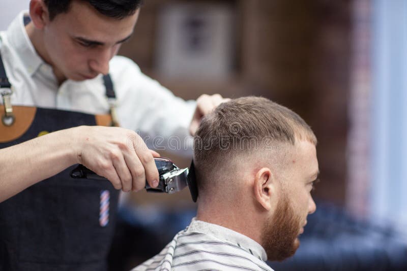 Barber Shaves the Client`s Head with a Shaving Machine Stock Photo ...