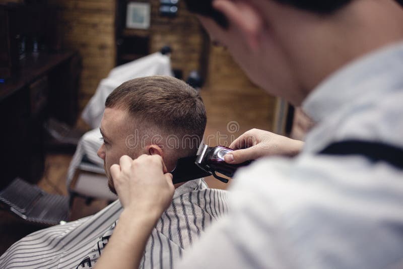 Barber Shaves the Client`s Head with a Shaving Machine Stock Image ...