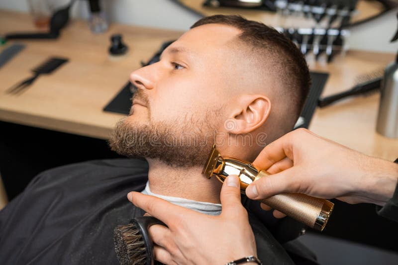Barber Skillfully Uses a Trimmer To Shape the Clients Beard, Focusing ...
