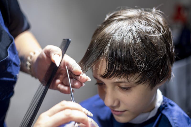 Barbeshoper Cuts the Bangs Under the Comb on the Wet Hair of the Little ...
