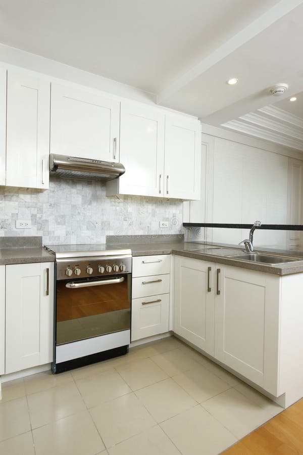 Bare, Clean Kitchen with an Oven, White Drawers and Cabinets Stock ...