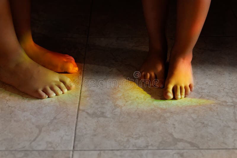 Bare Feet of Children Colored by the Diffraction of Light. Stock Photo ...