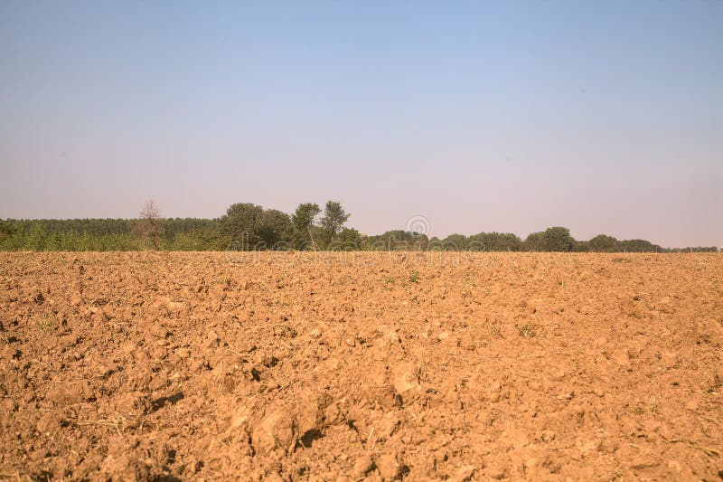 A Bare Field in the Countryside with Trees in the Distance on a Clear ...