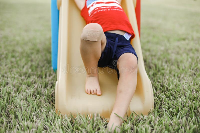 Barefoot child on a slide stock image. Image of playground - 260541903