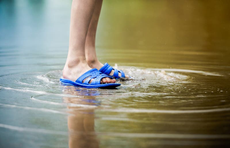 Barefoot the Feet of the Boy and Ankle in a Mud Puddle. Stock Image ...