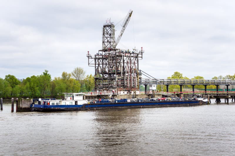 Barge Loading Oil on a Cloudy Spring Day Stock Image - Image of ...