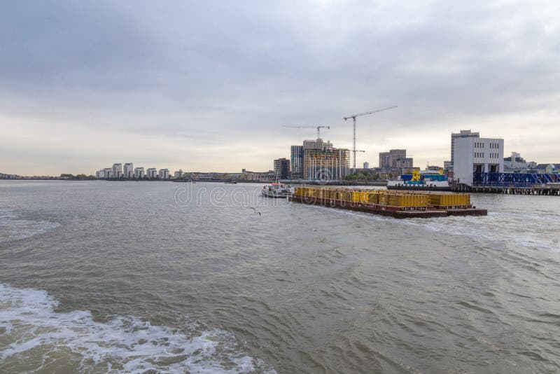 Barge Pulling a Load of Containers Downriver at Woolwich, London Stock ...