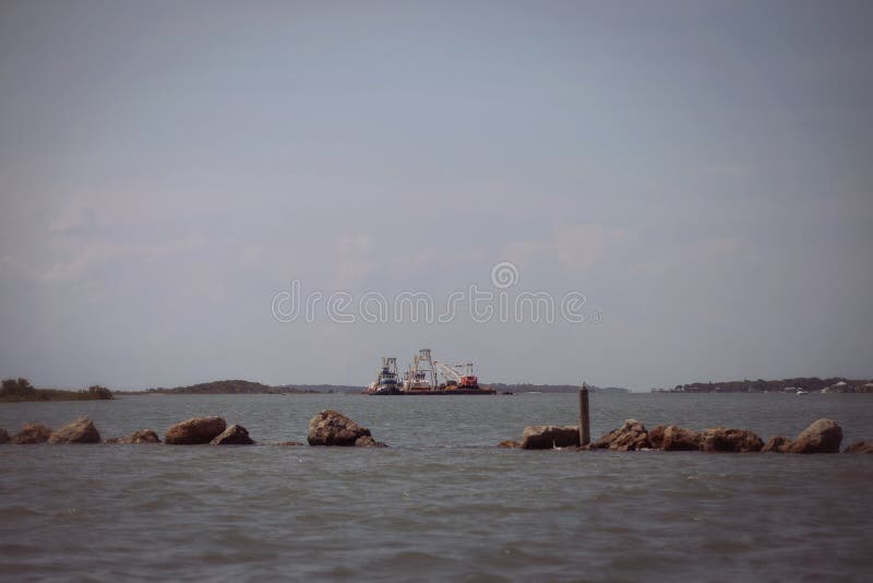Barge and Natural Jetty in the Inlet of the Atlantic Ocean Stock Photo ...