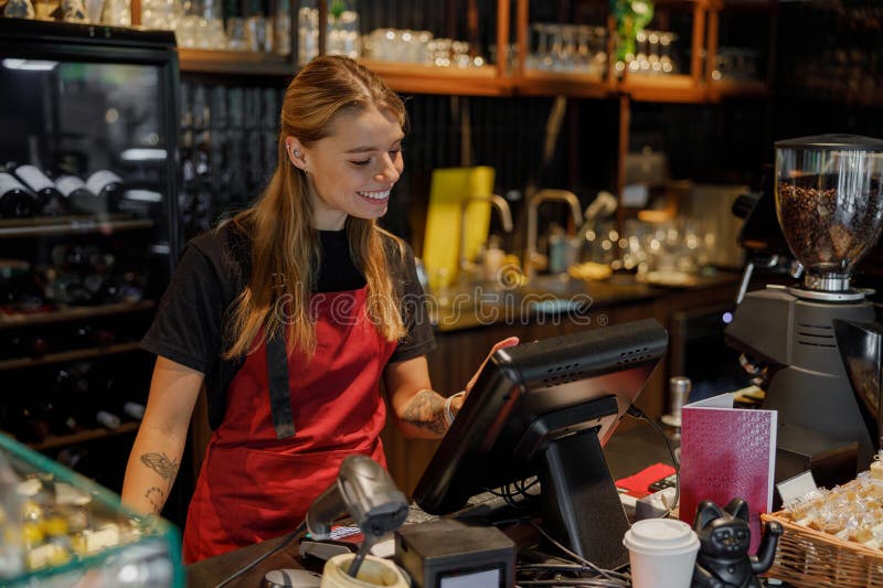A Barista is Actively Working at a Bustling Coffee Shop that Utilizes a ...
