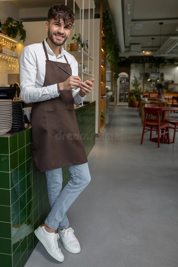 Barista with Beard Standing in Bar Counter and Using Organizer for ...