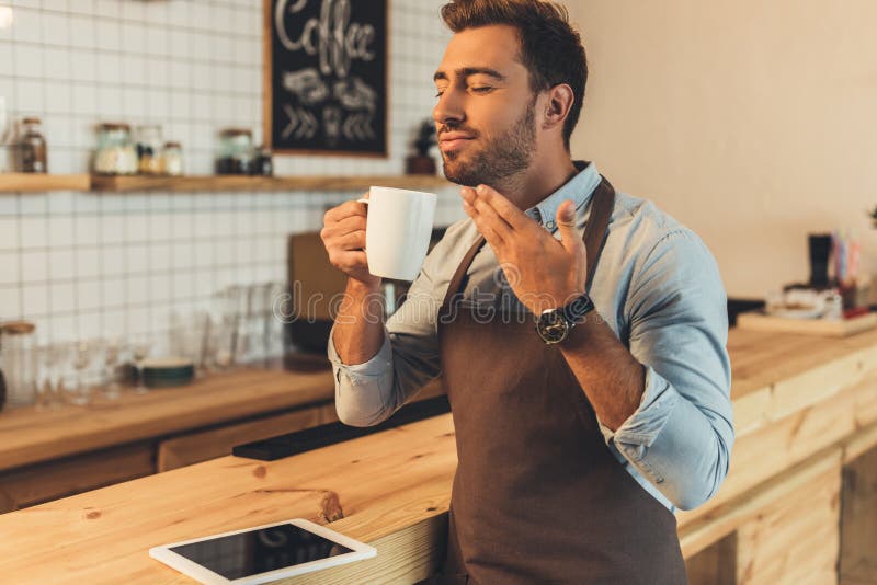 Barista with cup of coffee stock photo. Image of worker - 102935046
