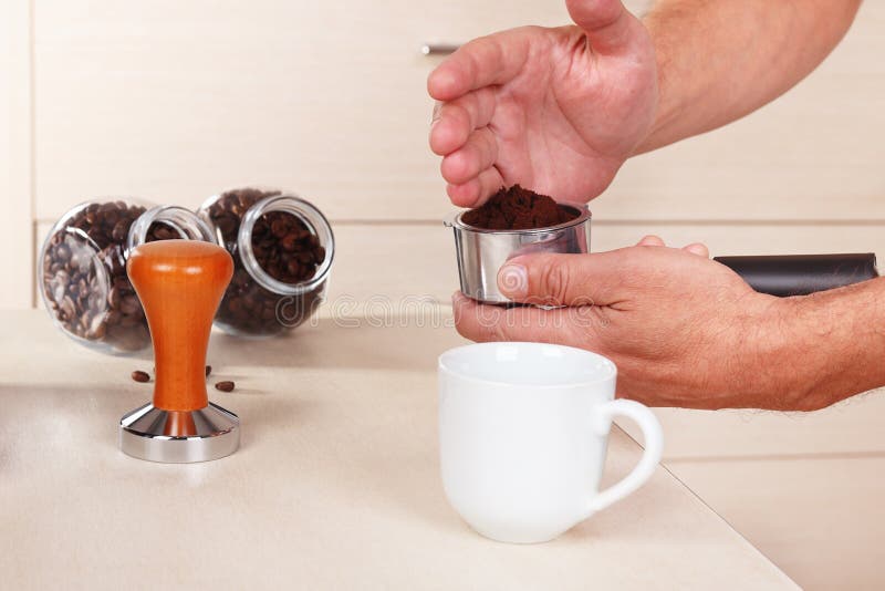Barista Levels the Ground Coffee in the Holder of Coffee Machine Stock ...