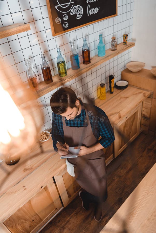 Barista Making Notes in Notebook Stock Photo - Image of alone, counter ...