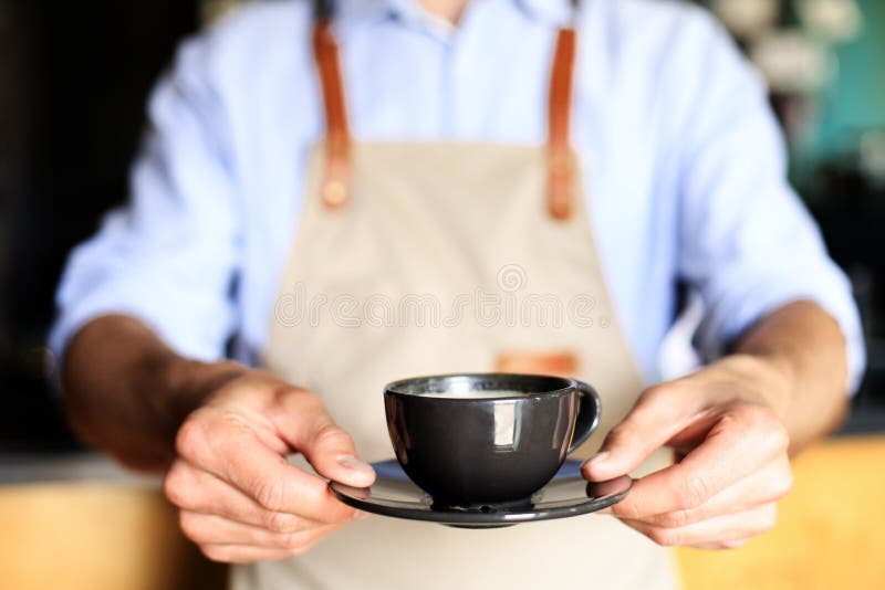 Handsome Barista Offering a Cup of Coffee To Camera at the Coffee Shop ... Handsome Barista Offering a Cup of Coffee To Camera at the Coffee Shop ...