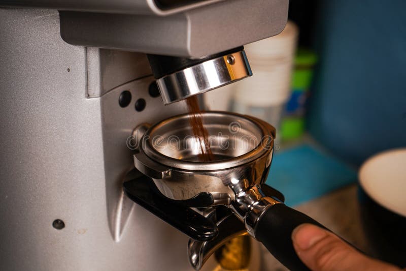 The Barista Positions the Portafilter Under the Grinder Chute for ...