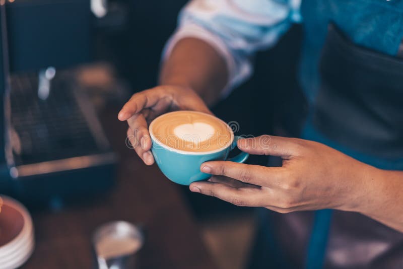 Barista Serving a Coffee To Customer at the Coffee Shop Stock Photo ...