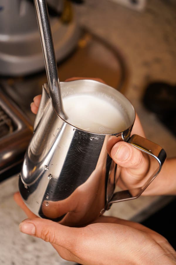 Barista Steaming Milk with a Coffee Machine Pitcher in a Modern Cafe ...