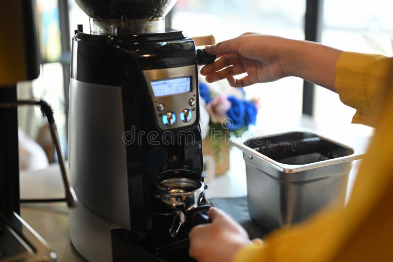 Barista Using Grinder Machine To Grinding Fresh Roasted Coffee Bean at ...
