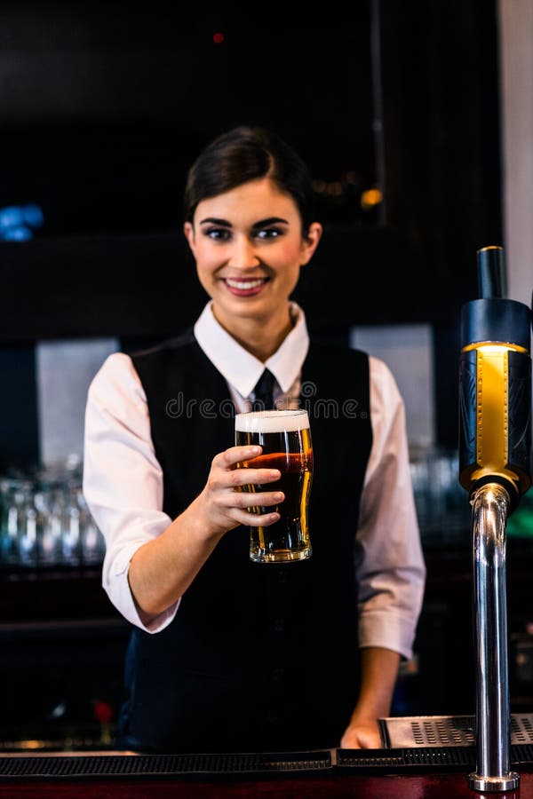 Barmaid serving a pint stock photo. Image of expensive - 66152230