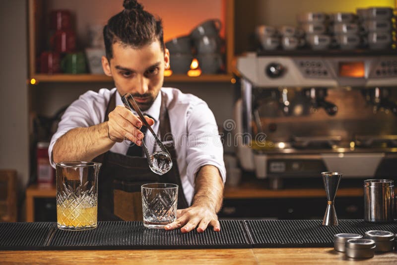Barman putting ice ball stock image. Image of beverage - 267554471