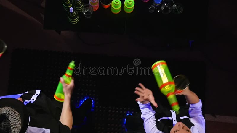 Barman Show. Two Barmen Juggle Bottles and Beaker for Mixing Stock ...